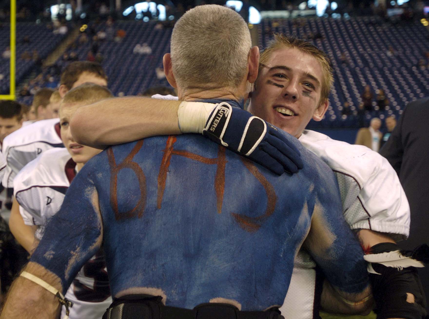 Nick Hall of Bellmont gets a hug from a fan after the team won the ...